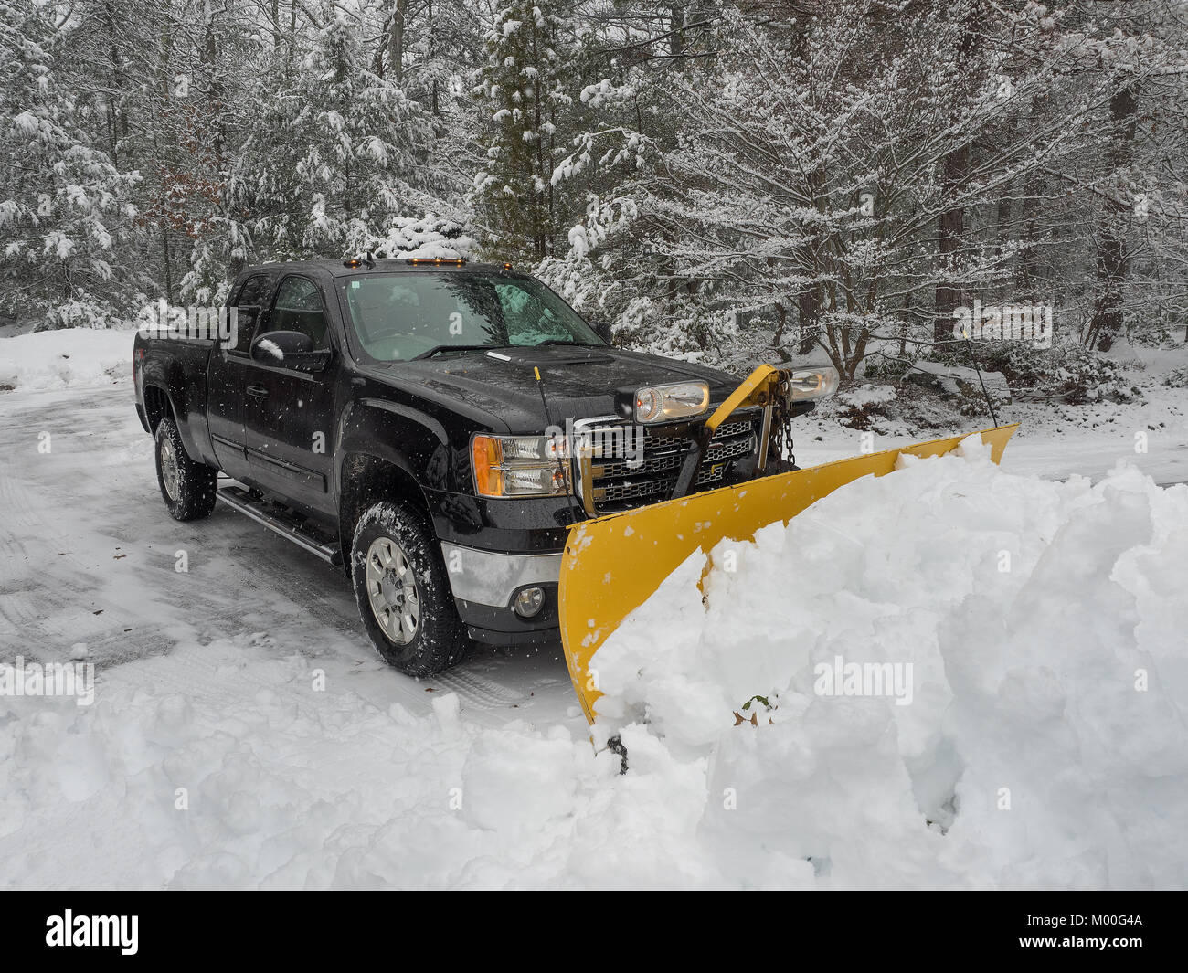 snow plow clearing a parking lot after storm Stock Photo - Alamy