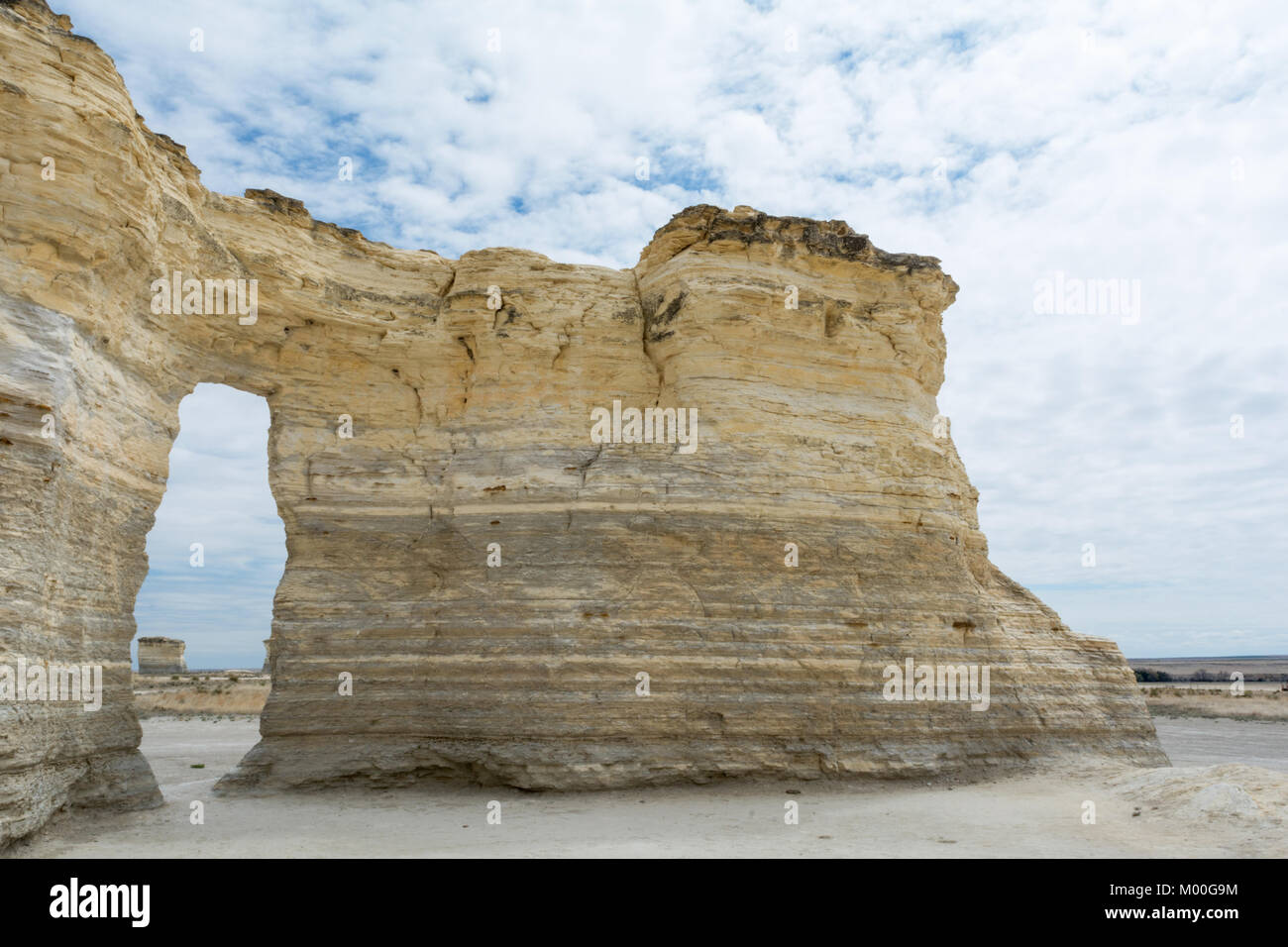 Distance limestone rocks can be seen through a natural limestone arch ...
