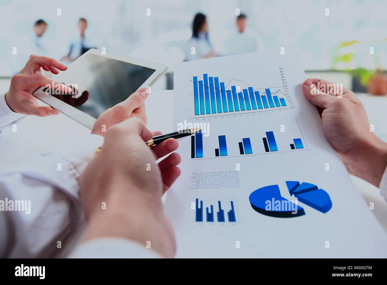 Close-up of business people working with documentation Stock Photo - Alamy