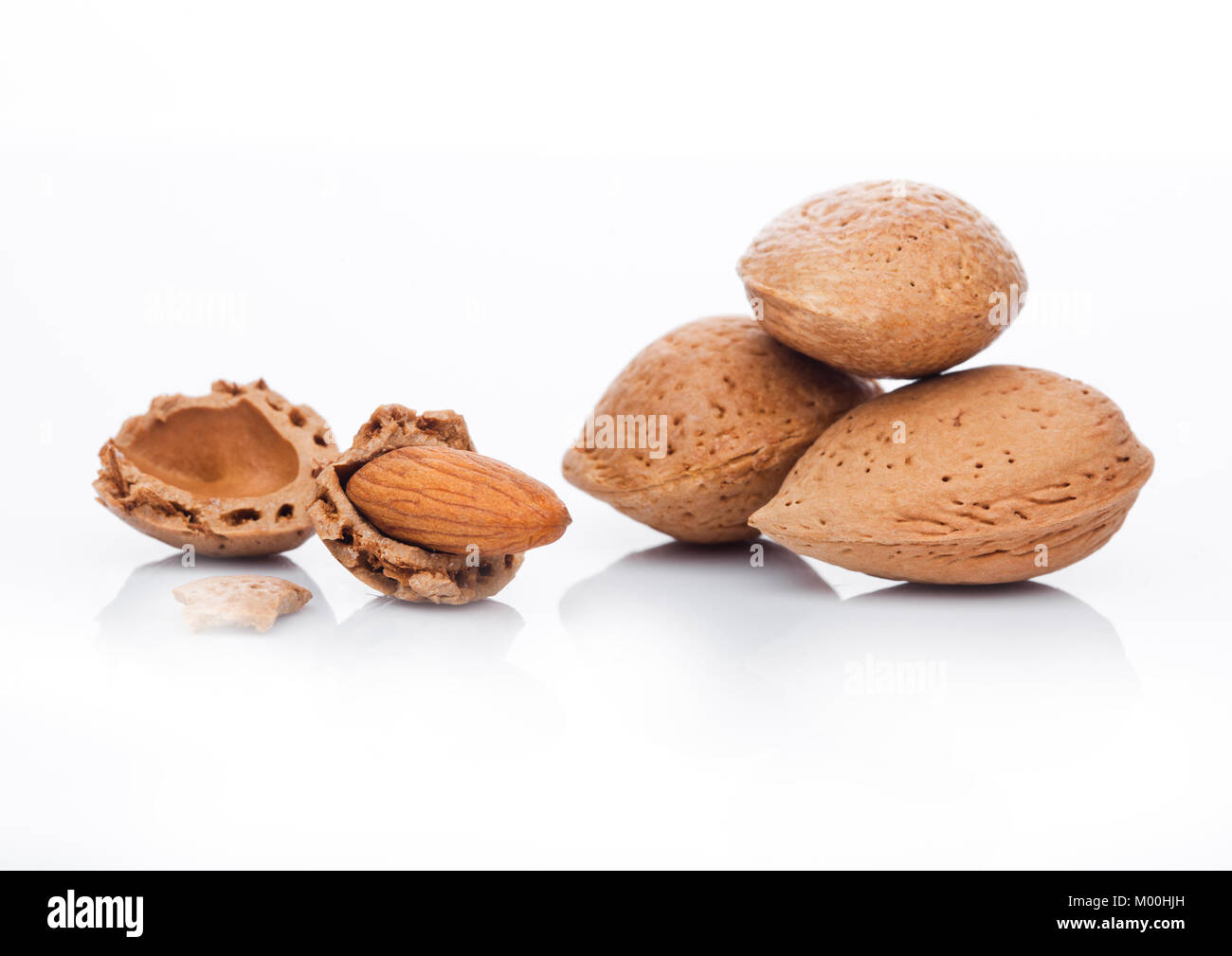 Raw almonds nuts with shell on white background with reflection Stock ...
