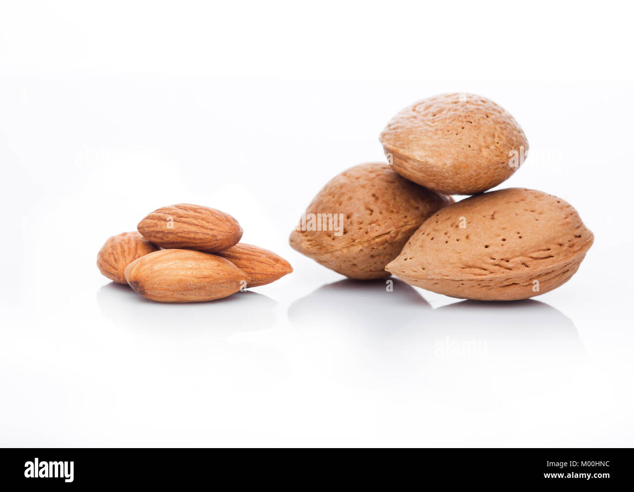 Raw almonds nuts with shell on white background with reflection Stock ...