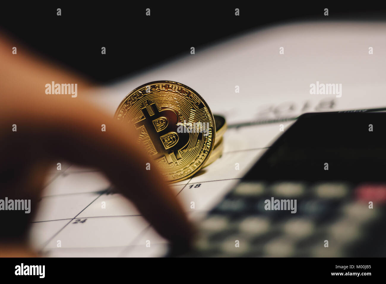 Calculating Bitcoin on a calendar file with dark background Stock Photo ...