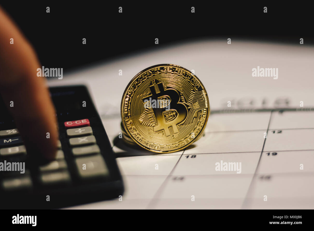 Calculating Bitcoin on a calendar file on dark background Stock Photo ...