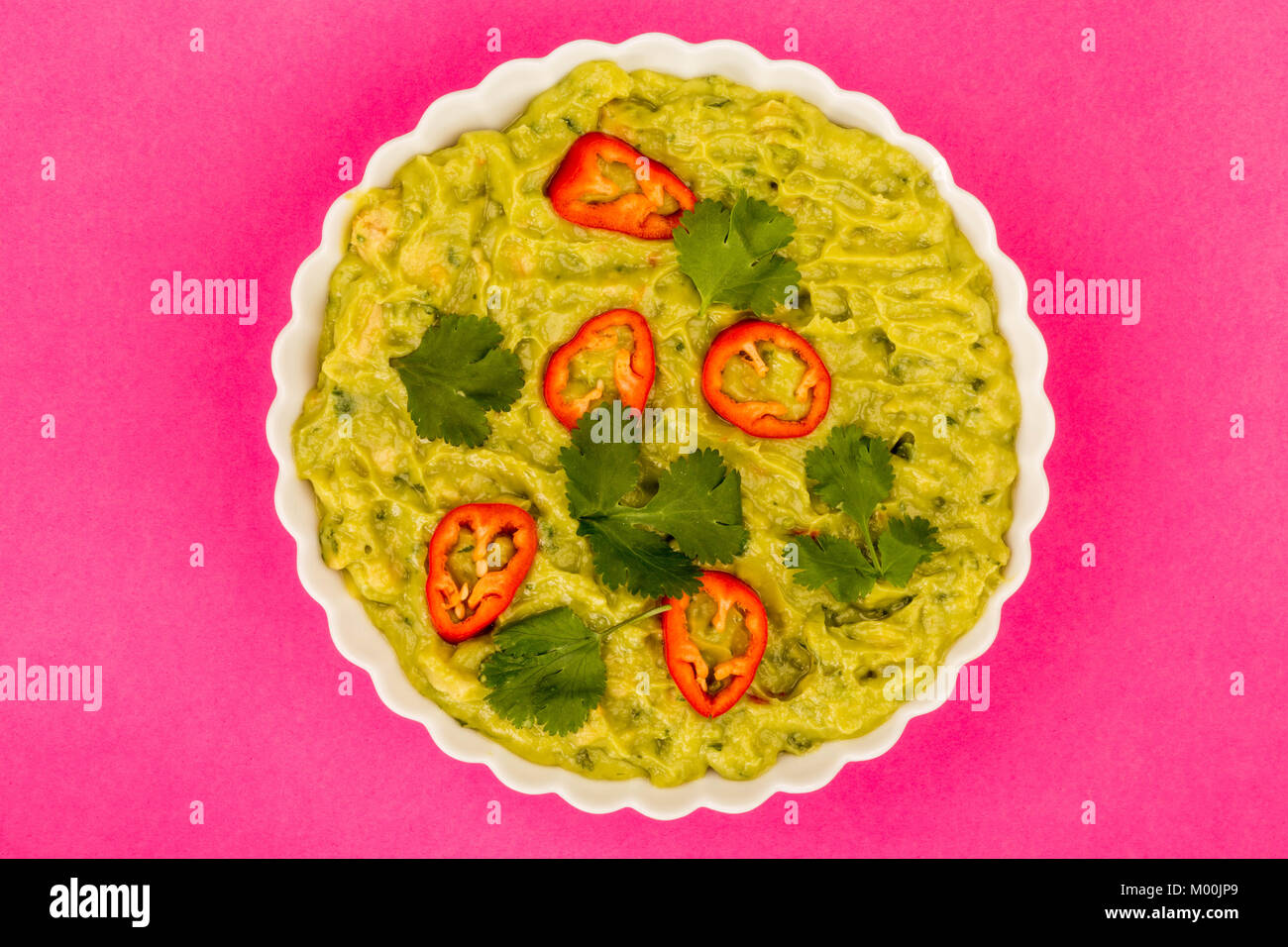 Vegetarian Mexican Style Guacomole Food Dip With Red Chillies Against A ...