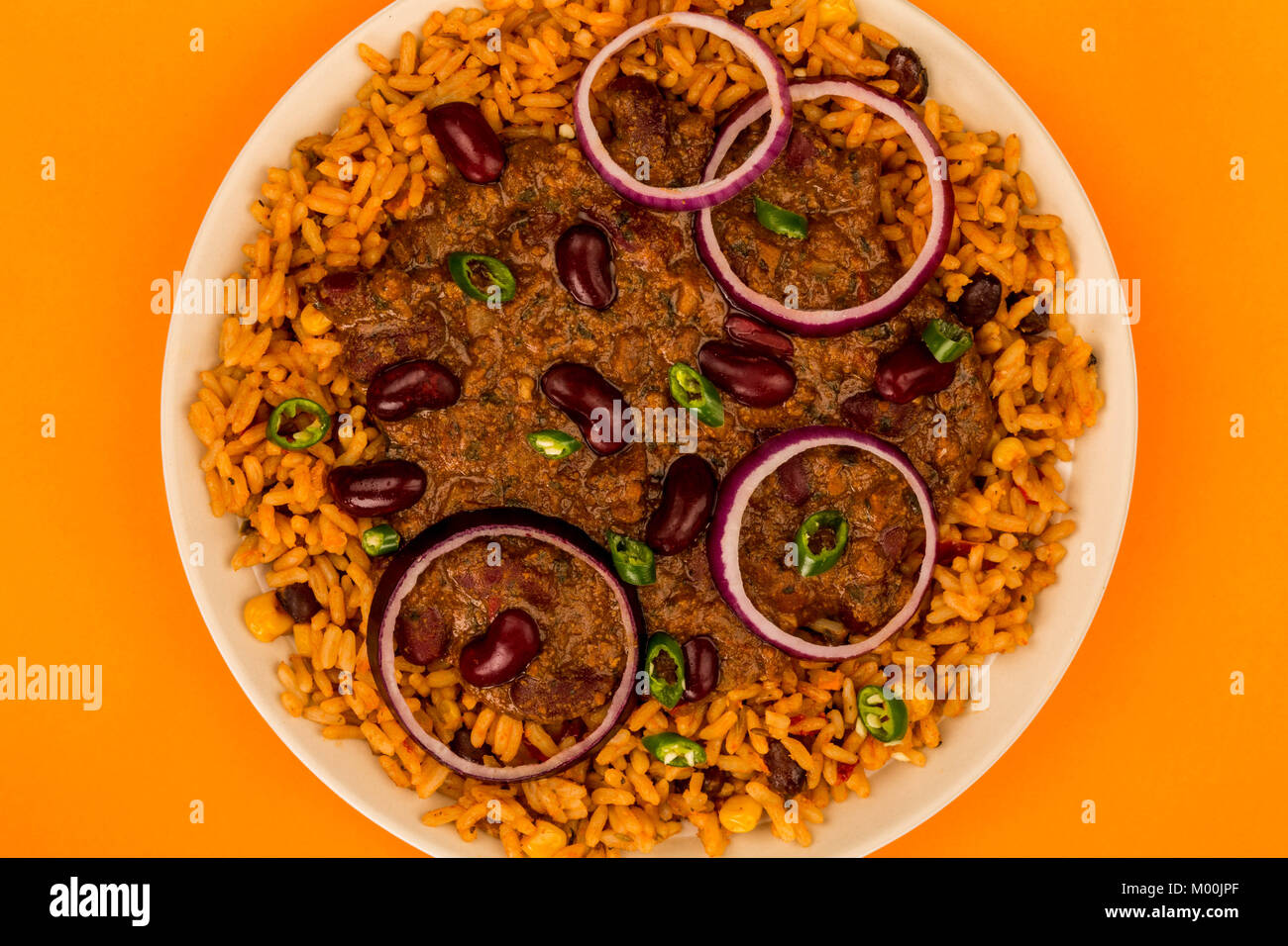 Mexican Style Chilli Con Carne With Rice and Onions Against An Orange ...