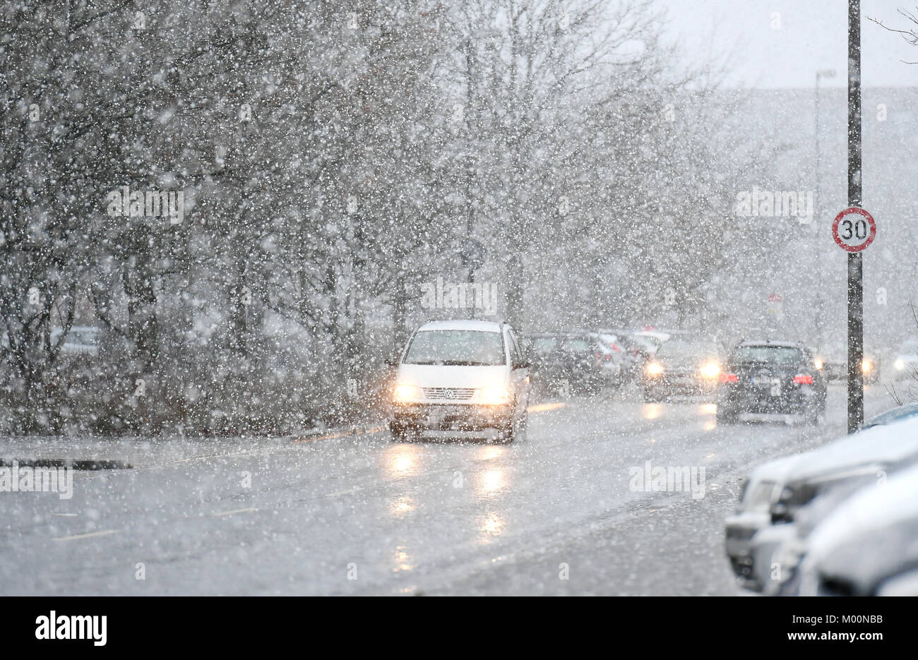 Langenhagen, Germany. 17th Jan, 2018. Cars drive along a street during ...