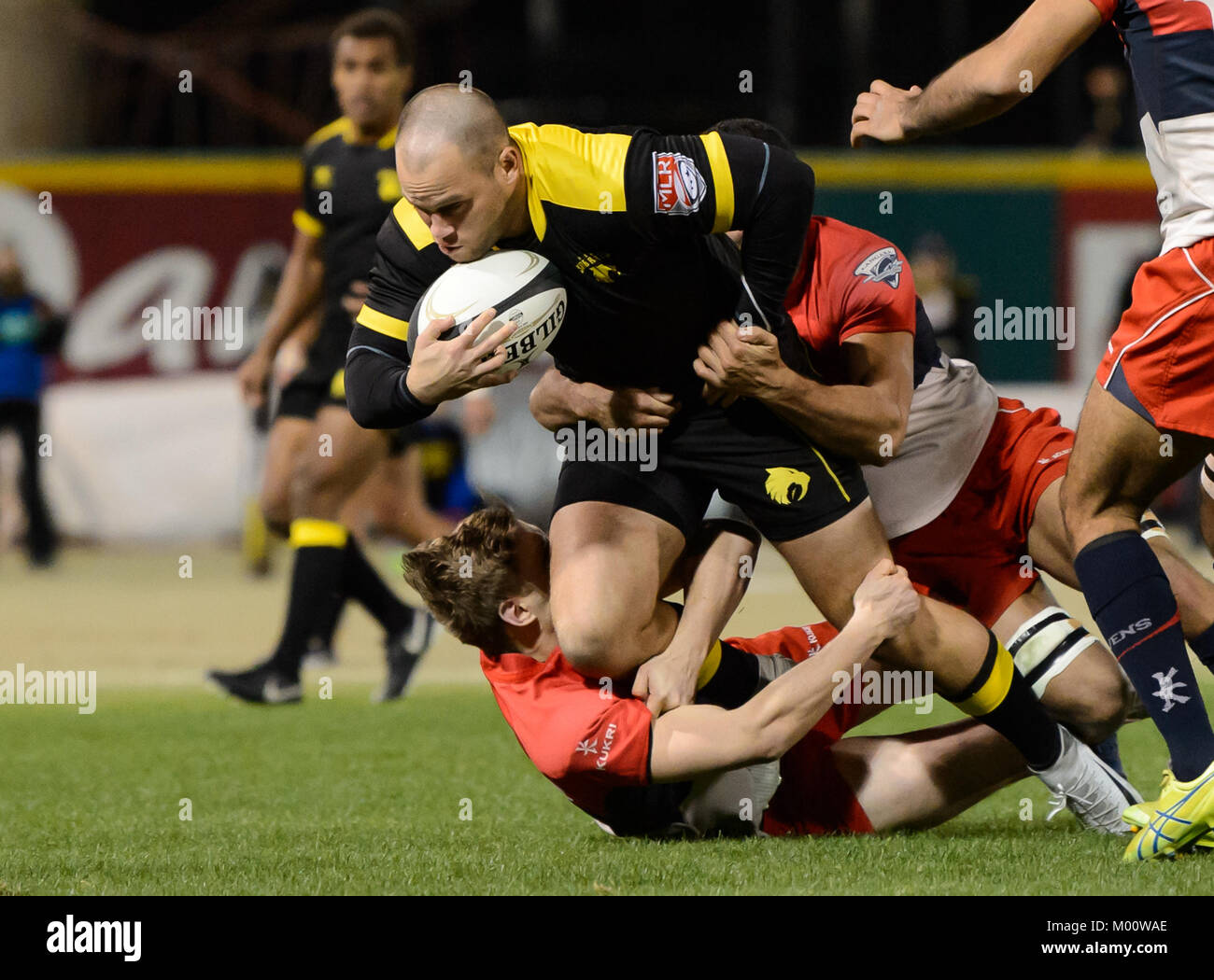 Houston SaberCats center Conor Mills (12) tries to back the grip of two ...