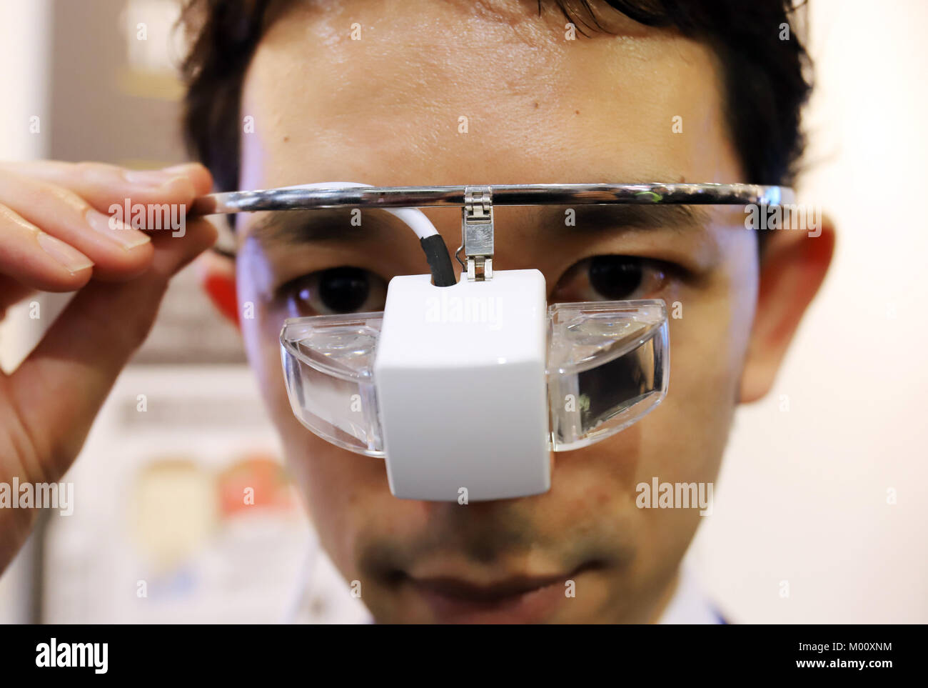 Tokyo, Japan. 17th Jan, 2018. An employee of Japanese eyeglasses ...