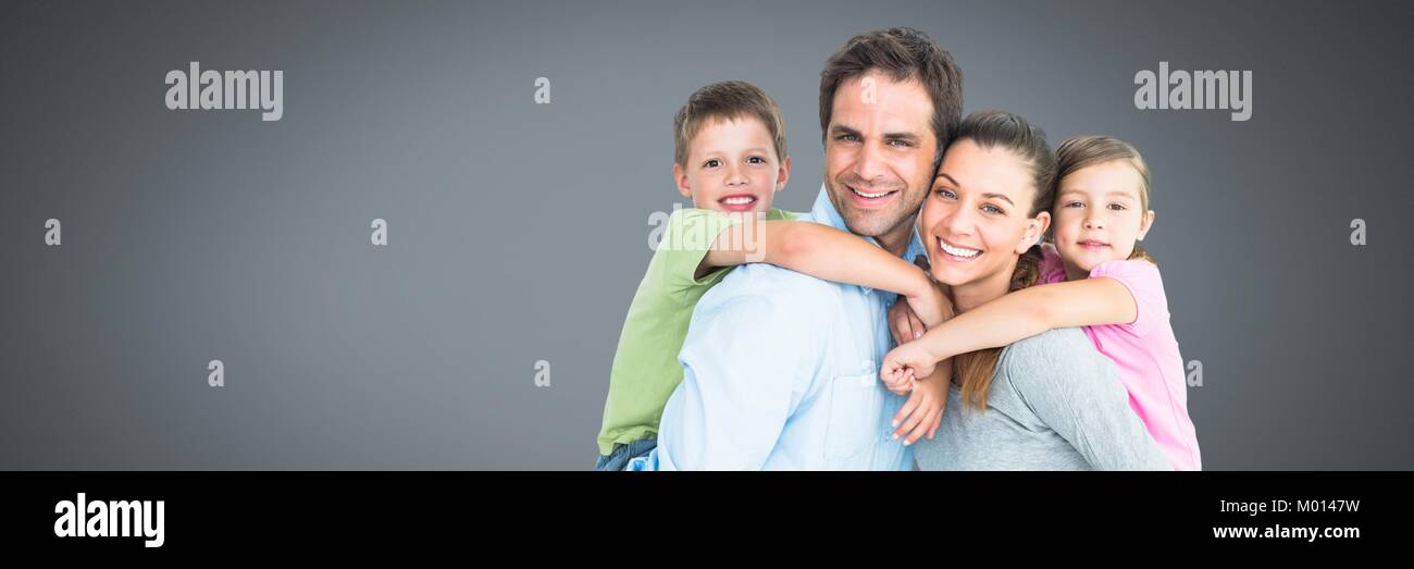 Family close together with grey background Stock Photo - Alamy