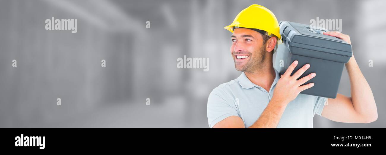 Construction Worker on building site holding toolbox Stock Photo - Alamy