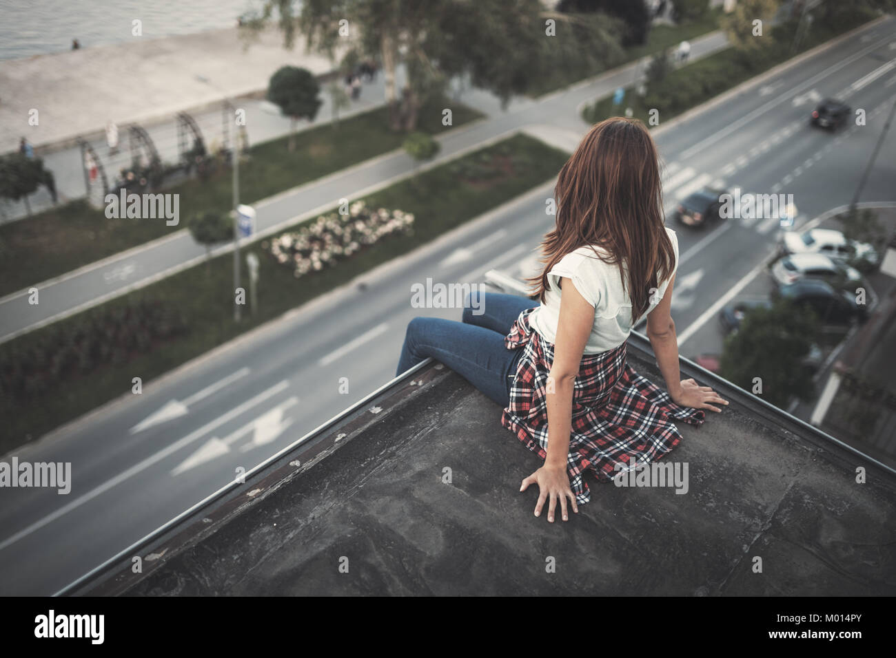 Attractive woman sitting on roof hi-res stock photography and images ...