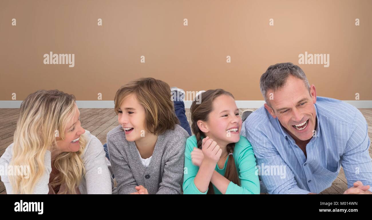 Family laughing together having fun with orange wall in room Stock ...