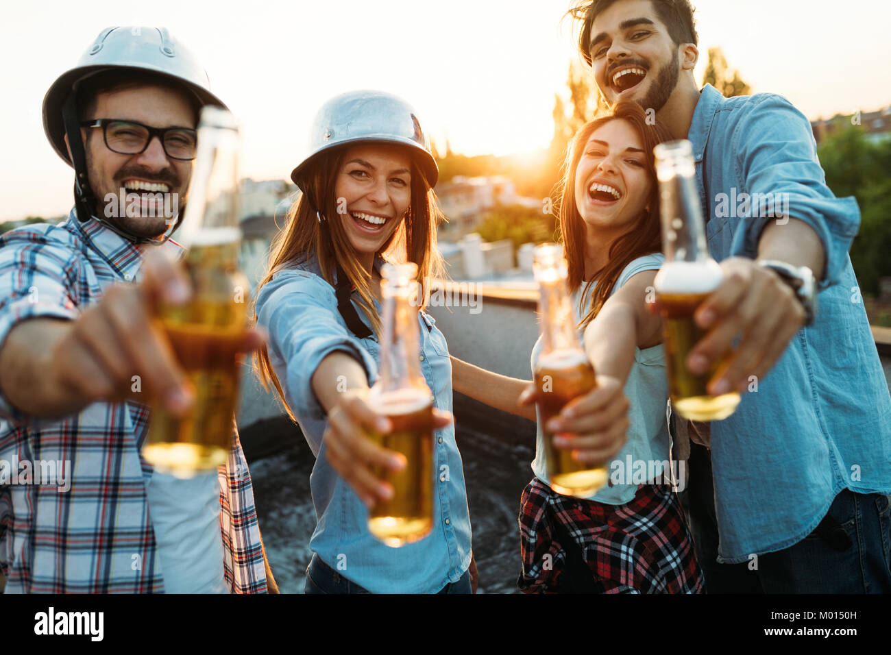 Group of happy friends having party on rooftop Stock Photo - Alamy