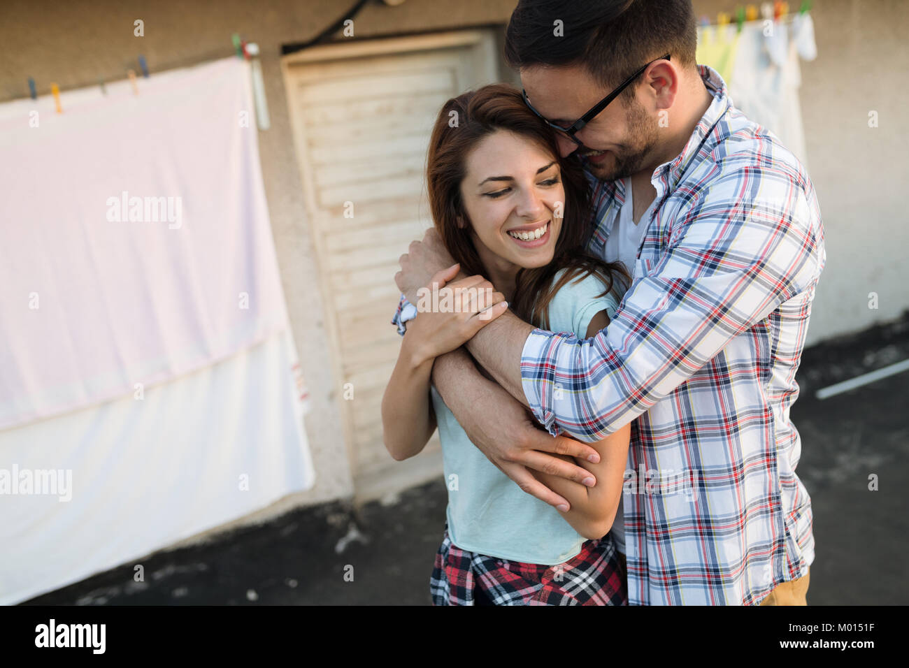 Beautiful couple hugging and smiling Stock Photo - Alamy