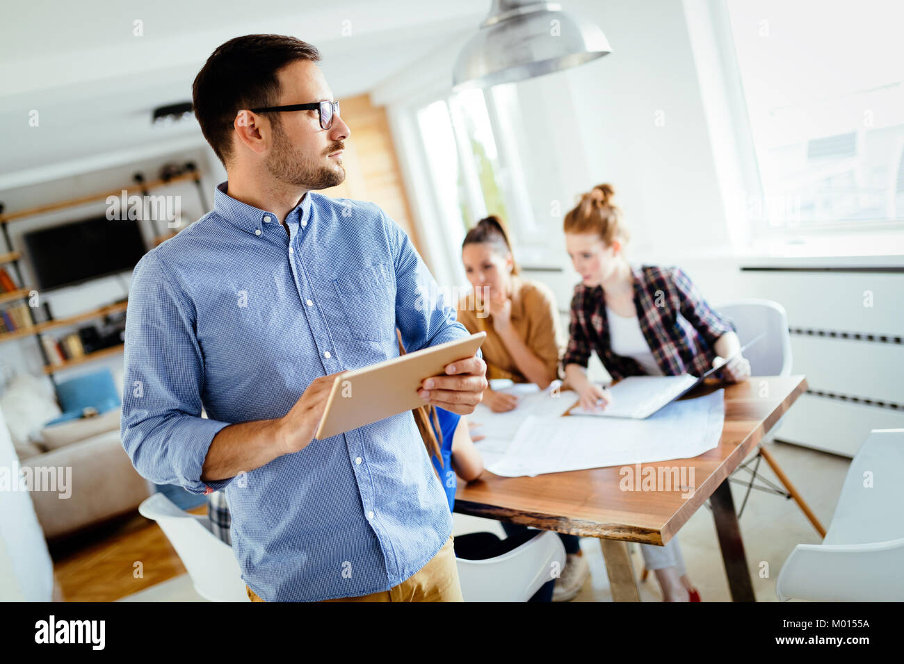 Group of architects working on project Stock Photo - Alamy