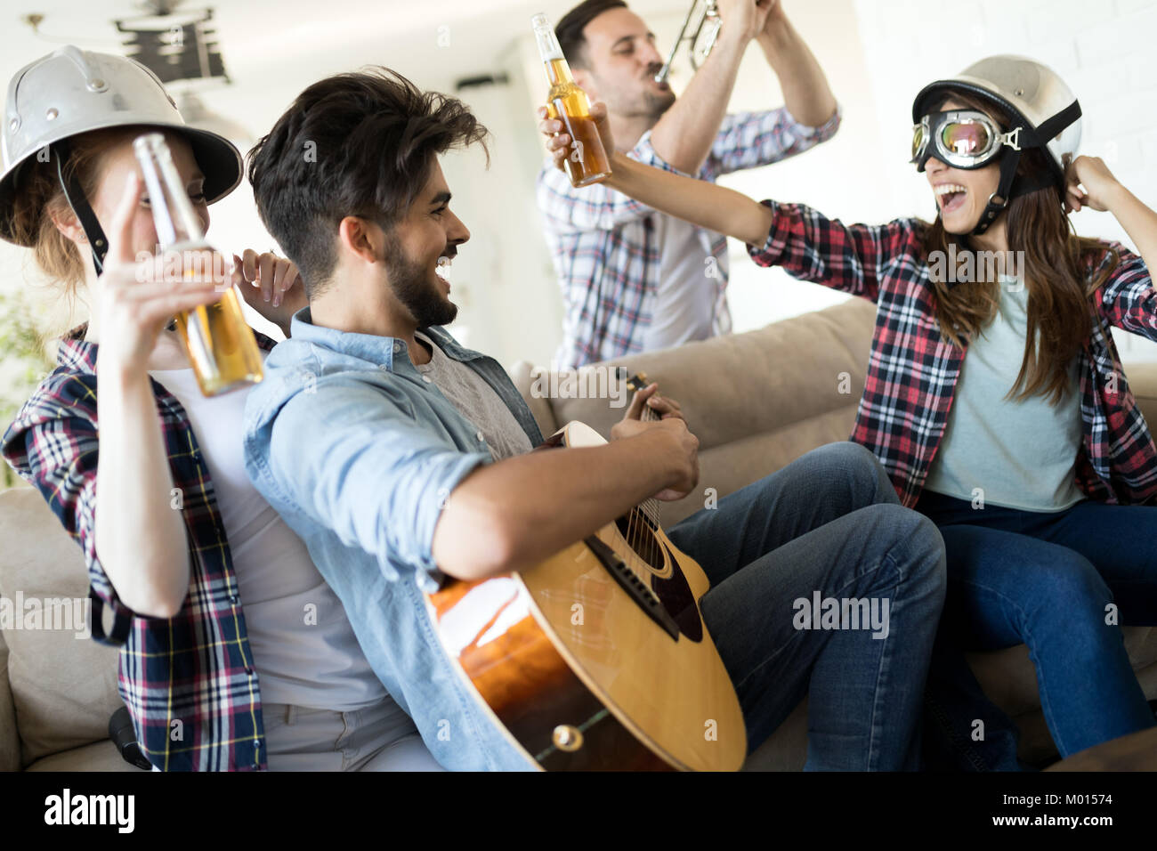 Cheerful friends having party together and playing instruments Stock ...