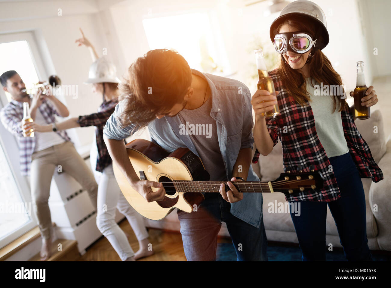 Cheerful friends having party together and playing instruments Stock ...