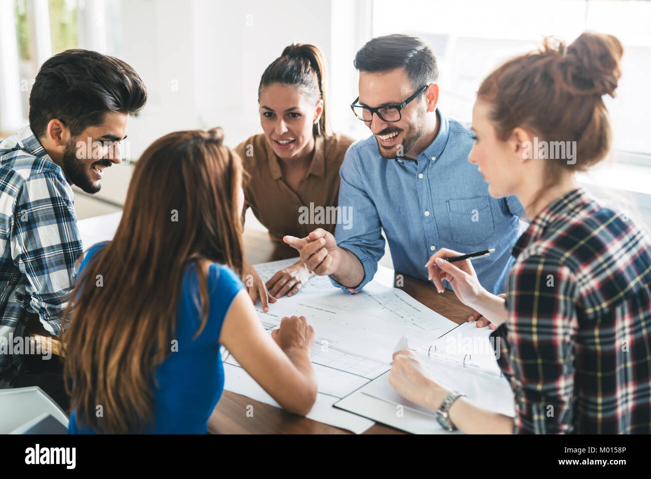 Image of business partners discussing documents and ideas Stock Photo ...