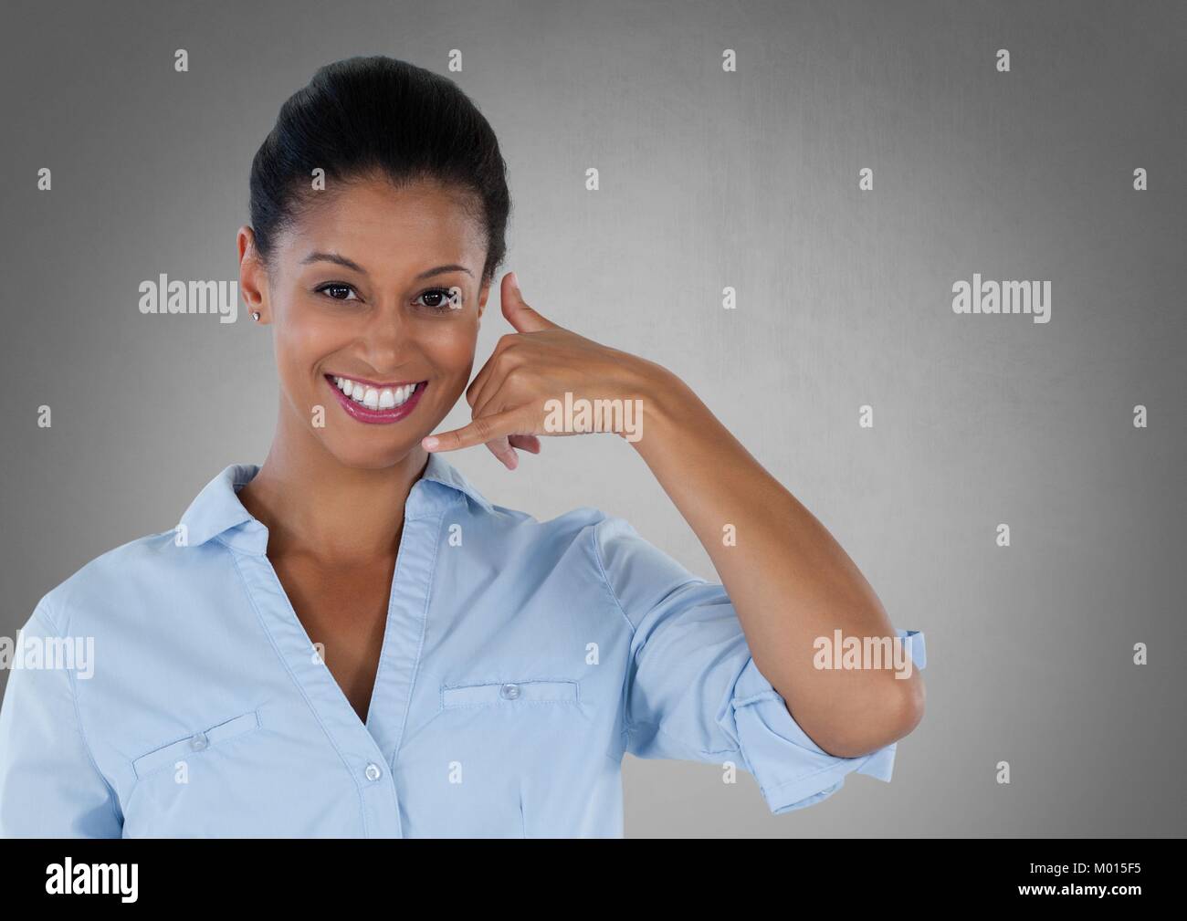 woman smiling with ring me sign Stock Photo - Alamy