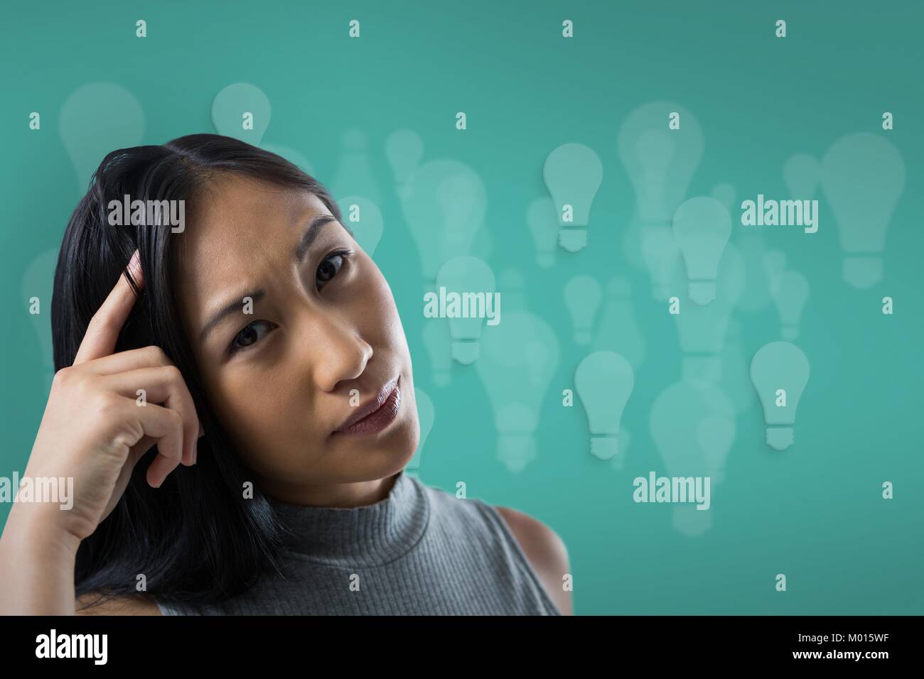Woman scratching her head on a blue background Stock Photo - Alamy
