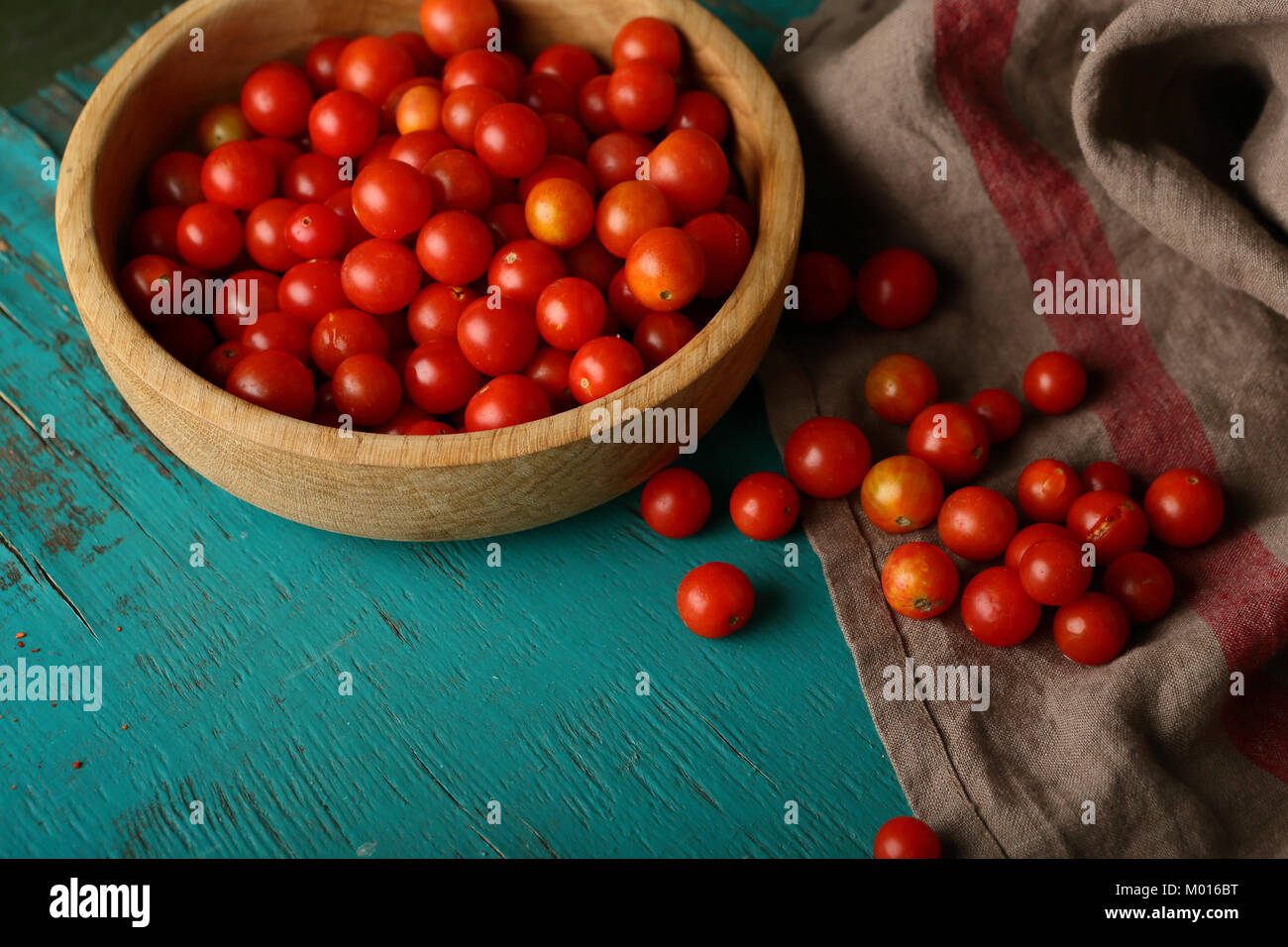 Small cherry tomatoes in wood bowl, food closeup Stock Photo - Alamy