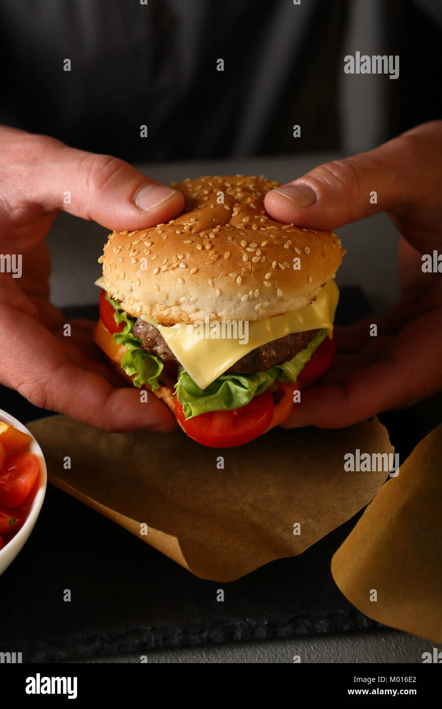 Fast food burger in man hands, food closeup Stock Photo - Alamy