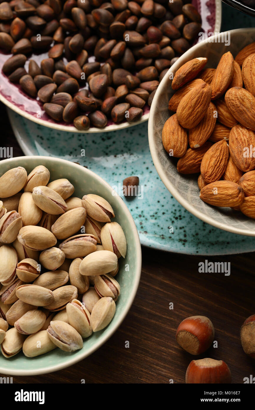 Mixed nuts in bowls on stone background Stock Photo - Alamy