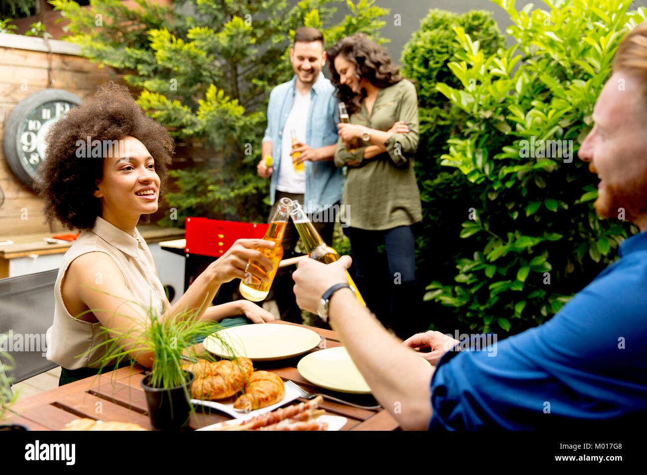 View at happy friends grilling food and enjoying barbecue party ...