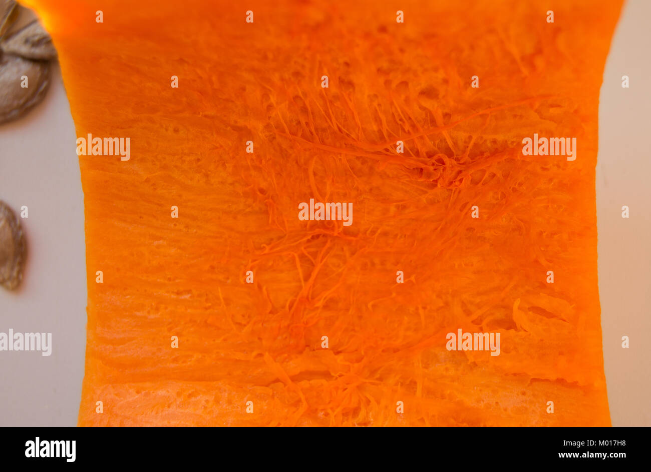 Dried pumpkin seeds with sliced ripe orange pumpkin Stock Photo - Alamy
