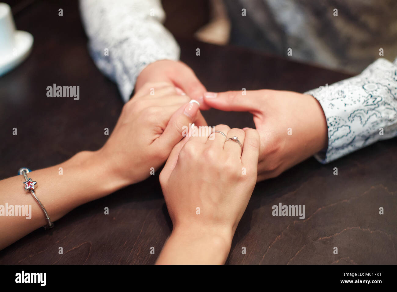 Holding hands across table hi-res stock photography and images - Alamy