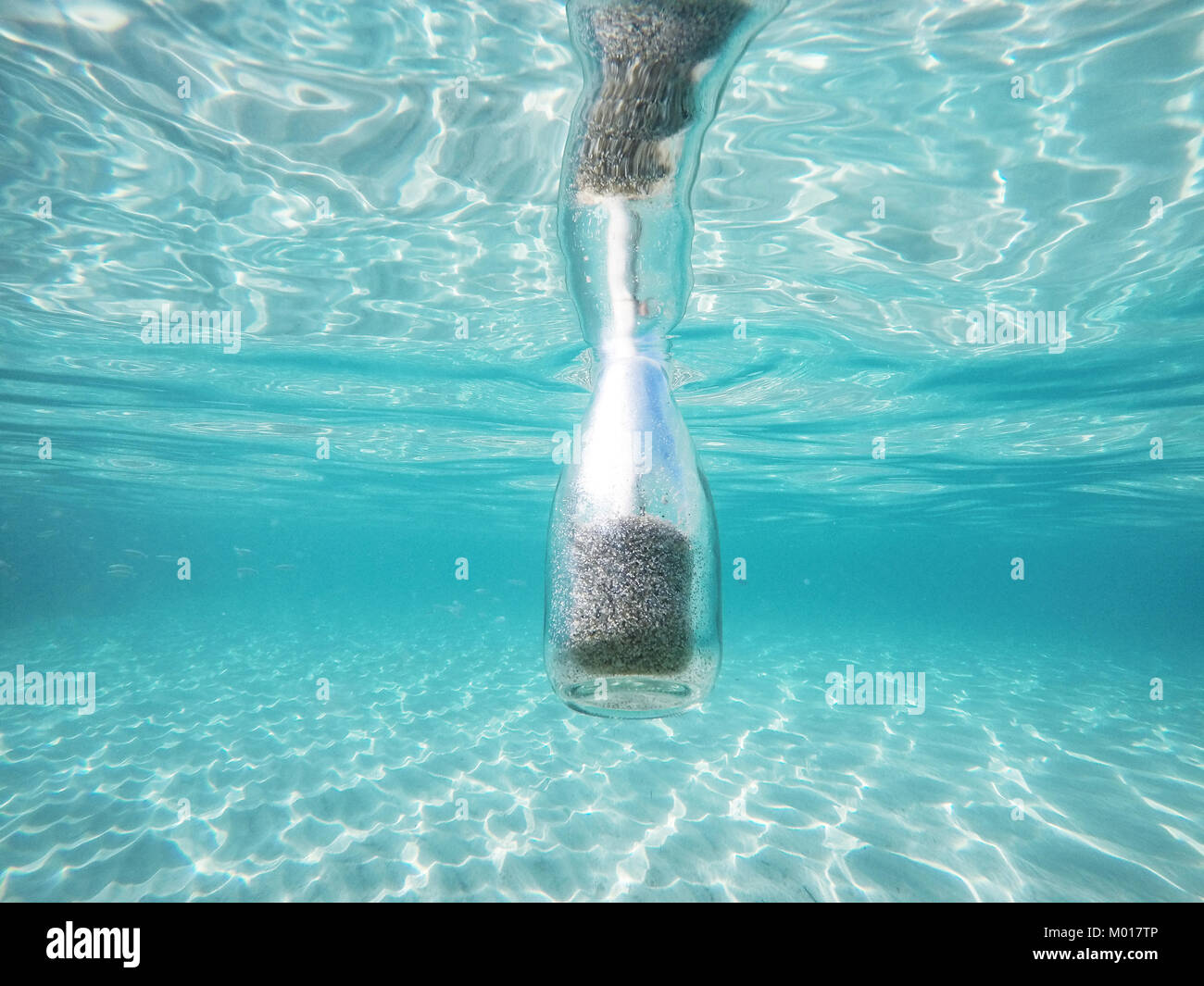Message in a bottle floating in the sea, Glass bottle with sand and ...