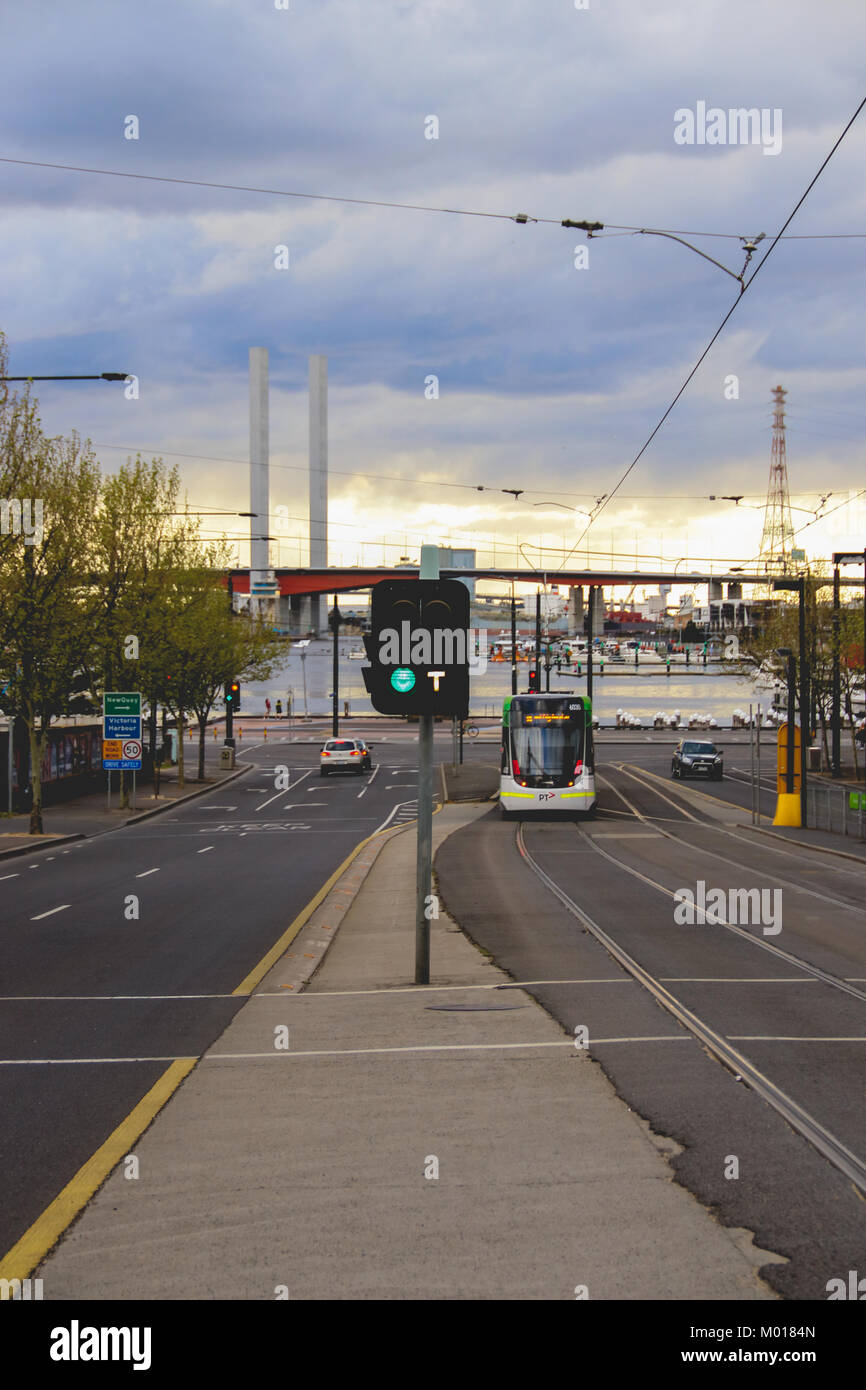 Melbourne city tram traveling down a quiet street at sunrise ...