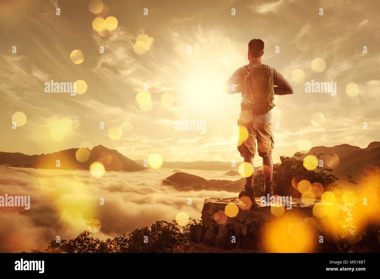 Hiker on a summit at sunset Stock Photo - Alamy
