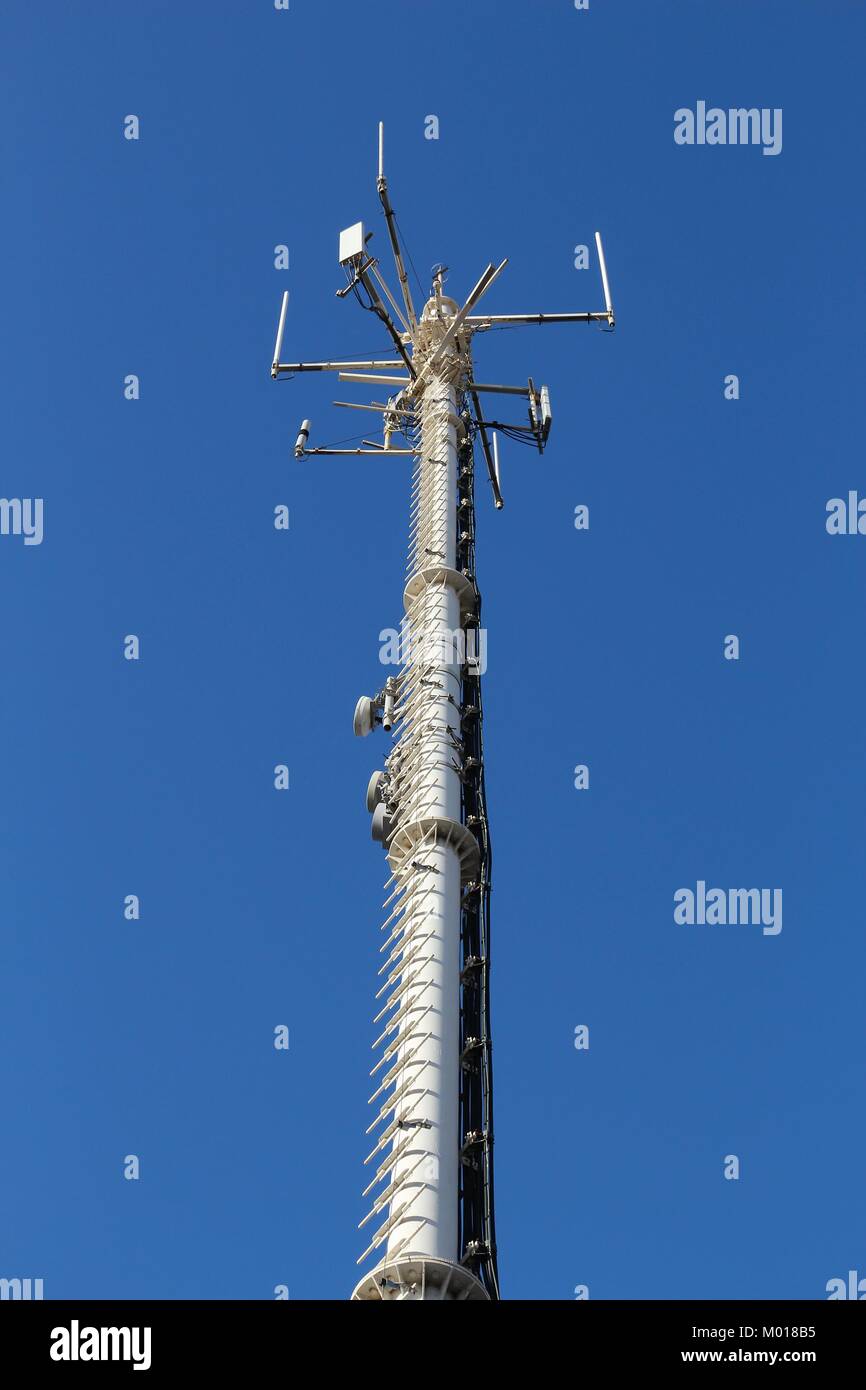 Telecommunications tower - transmitter pole with antennas and aerials ...