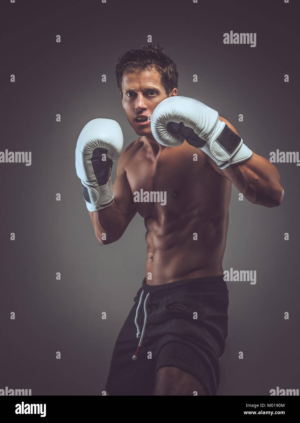 Muscular boxer in white gloves Stock Photo - Alamy