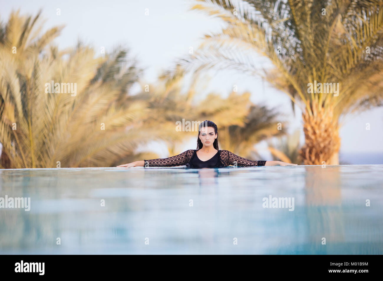 Infinity Pool Woman Palm Tree High Resolution Stock Photography and ...