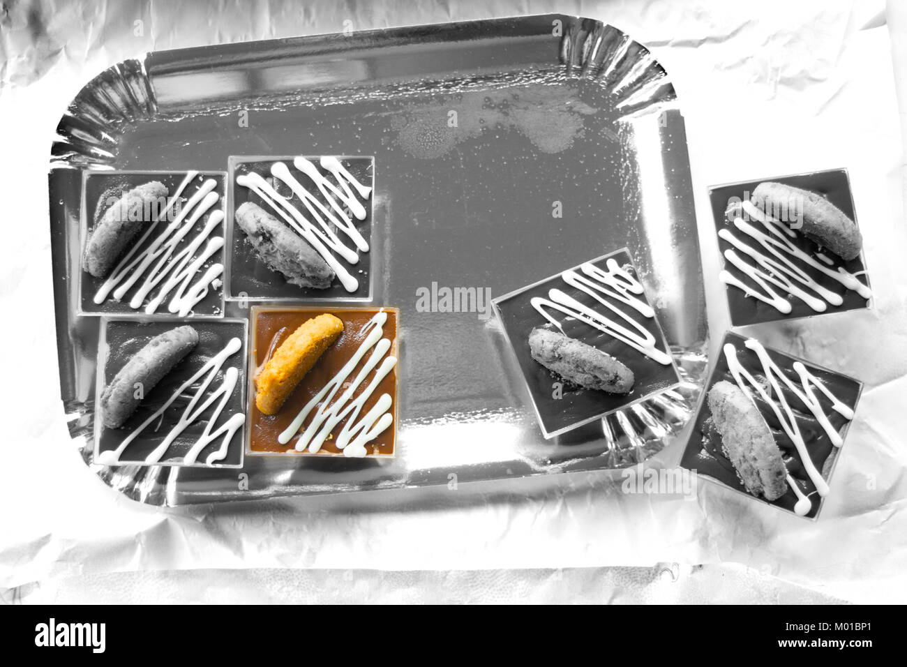 colored pastry made with melted chocolate on black and white background ...