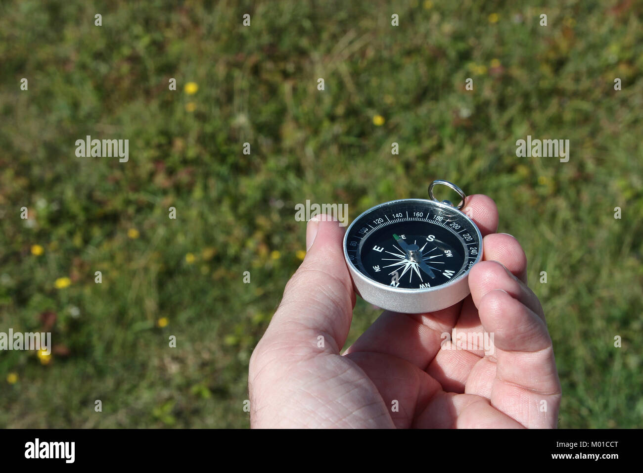 portable compass hold in hand for navigation Stock Photo - Alamy