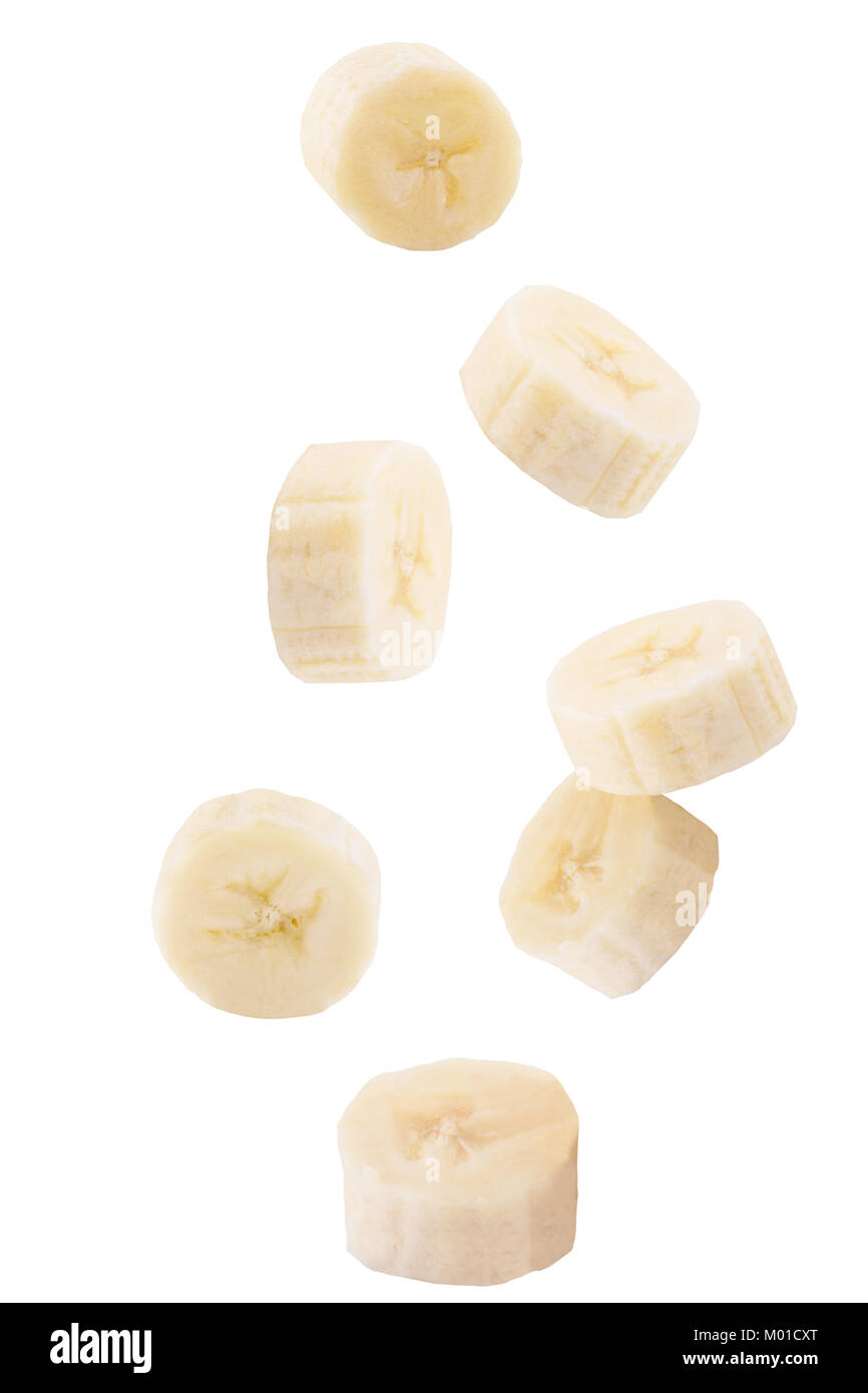 Isolated falling fruits. Falling sliced banana fruit isolated on white ...