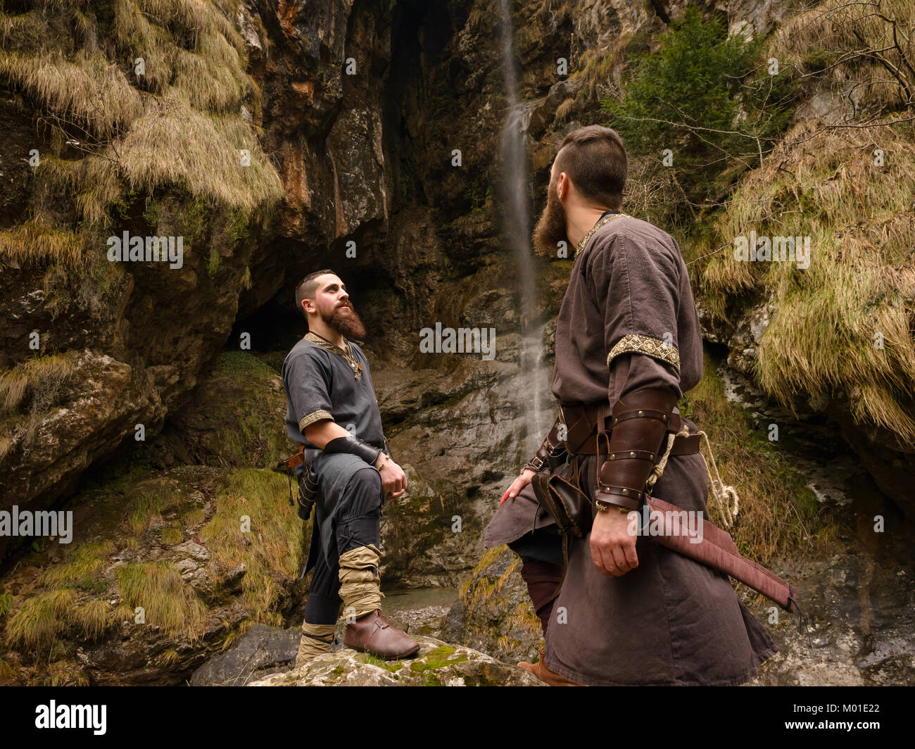 two Vikings under a waterfall Stock Photo - Alamy
