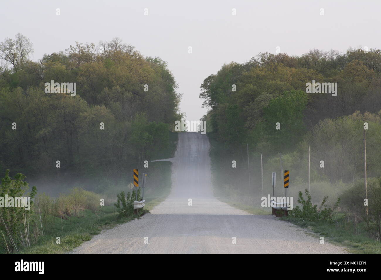 Dusty dirt road going over a hill into the distance Stock Photo - Alamy