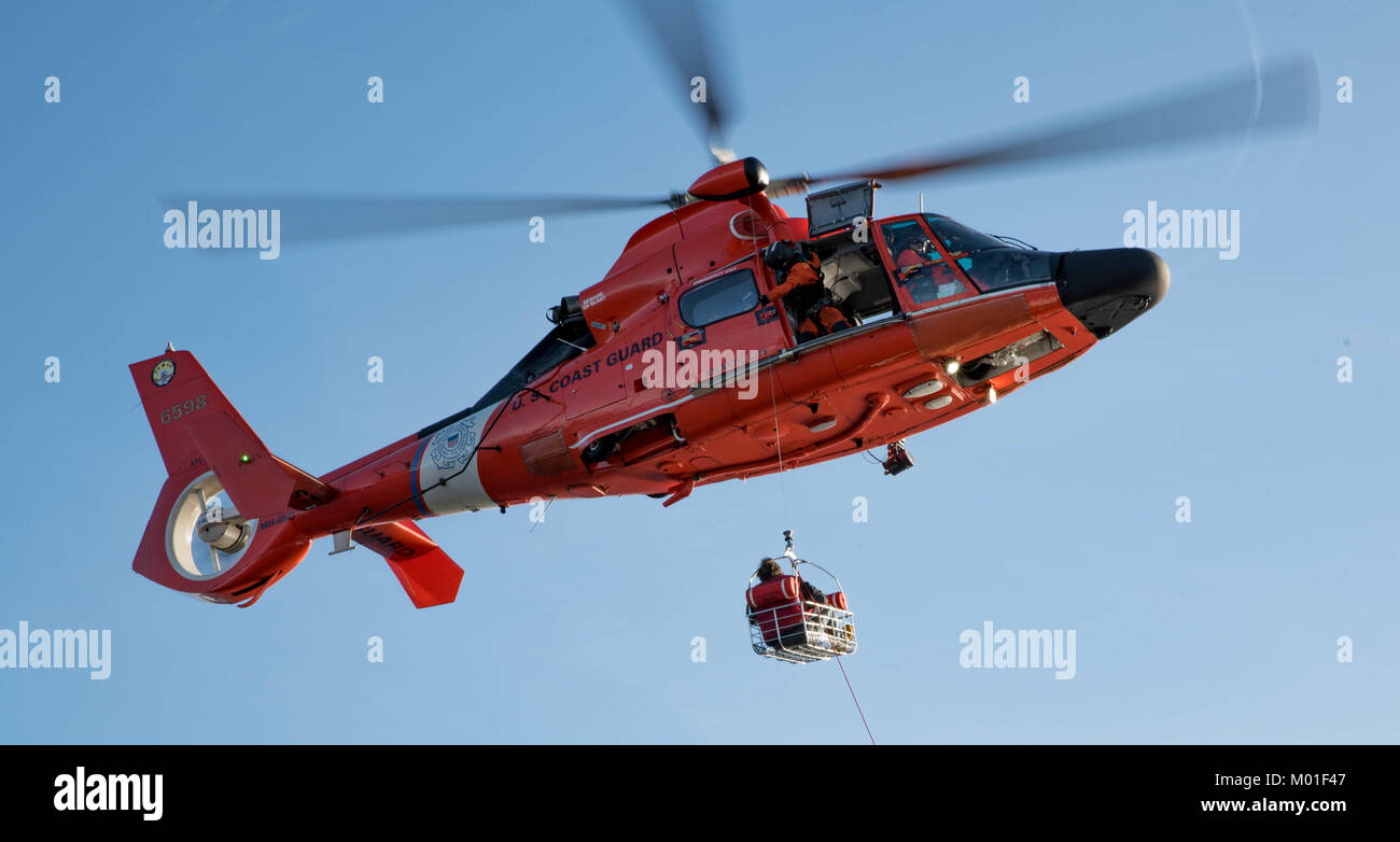 An MH-65 Dolphin rescue helicopter crew medevacs an ill fisherman from ...