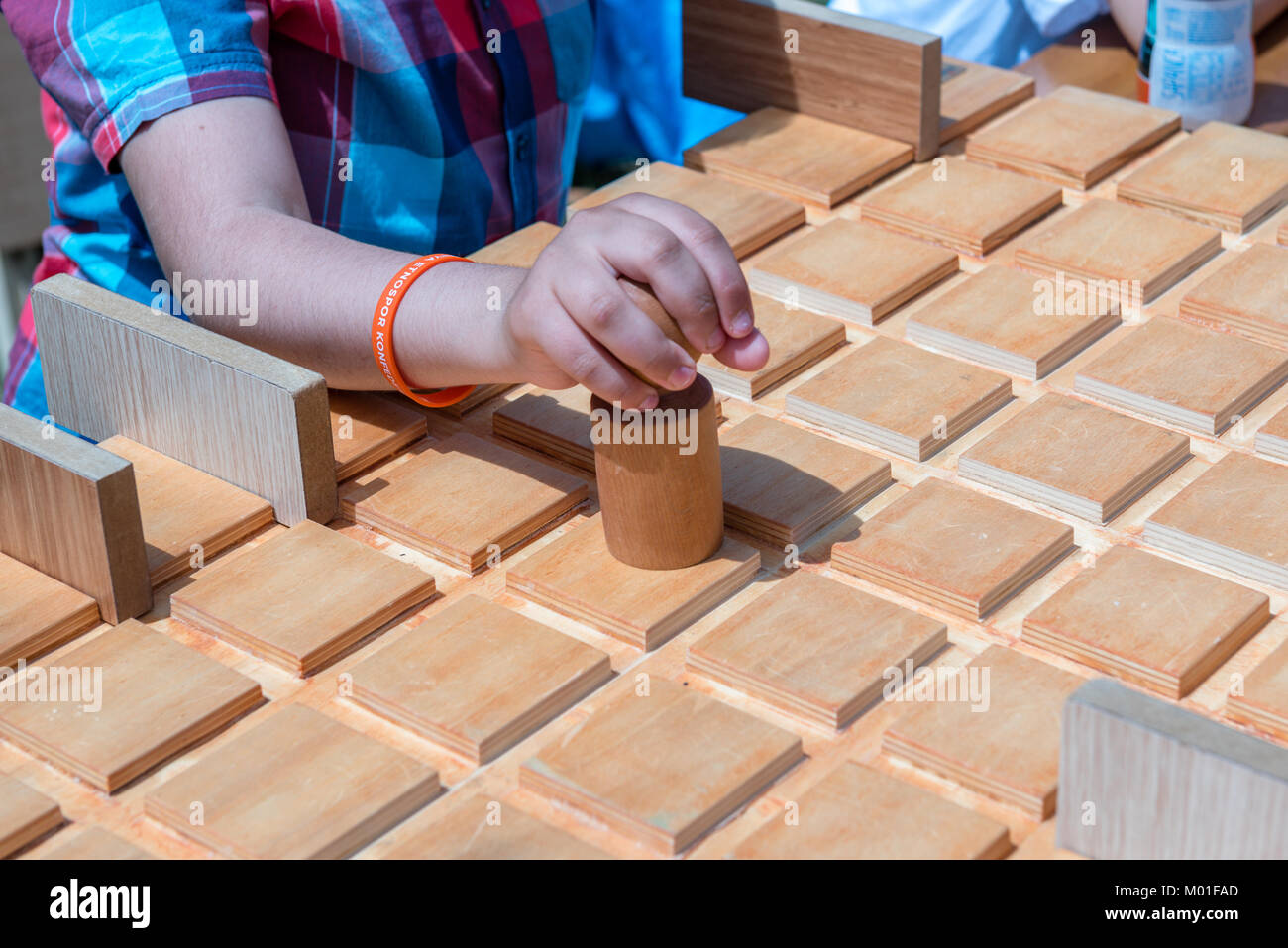 Unidentified children play a traditional Turkish wooden puzzle game ...