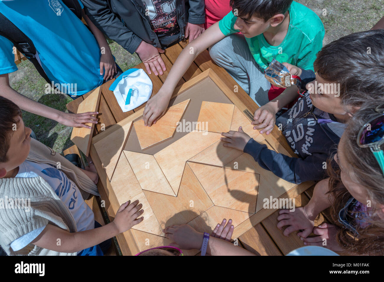 Unidentified children play a traditional Turkish wooden puzzle game ...