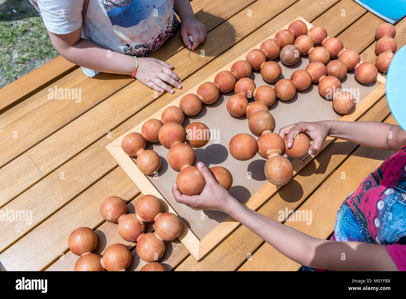 Unidentified children play a traditional Turkish wooden puzzle game ...