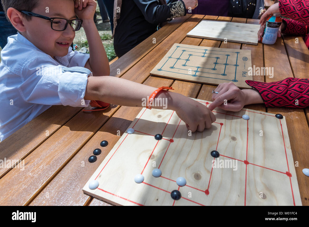 Unidentified children play a traditional Turkish wooden puzzle game ...