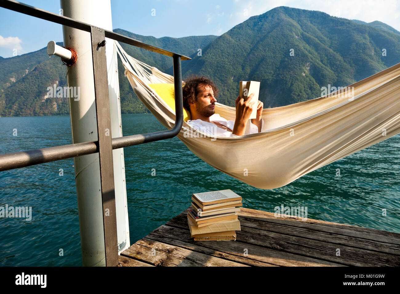 portrait of young man on the dock of Lake Stock Photo - Alamy
