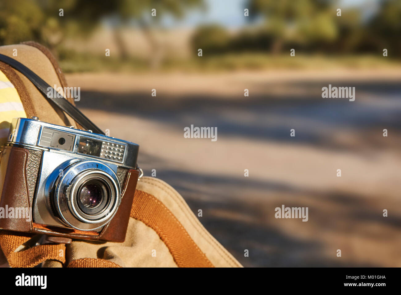 Carrying a vintage camera on the countryside. Film photography ...