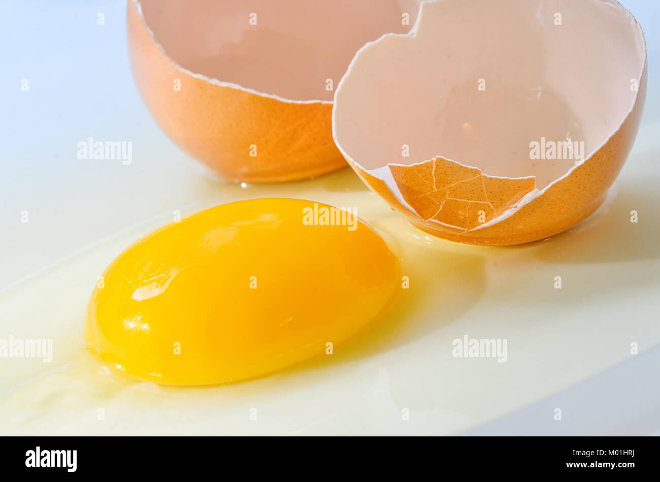Broken fresh egg isolated on white table Stock Photo - Alamy