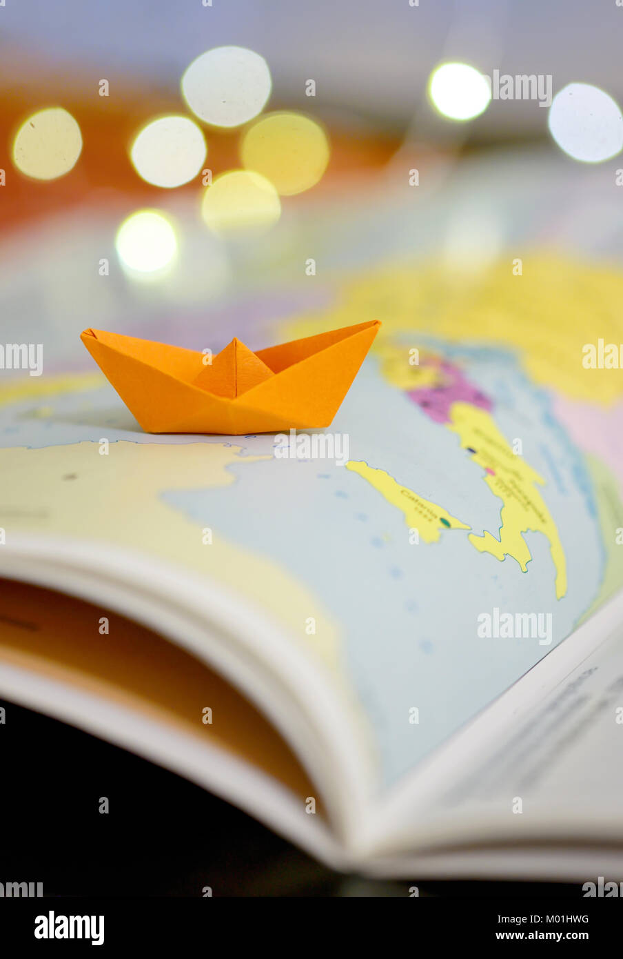 Paper boat on a atlas book map of the world Stock Photo - Alamy